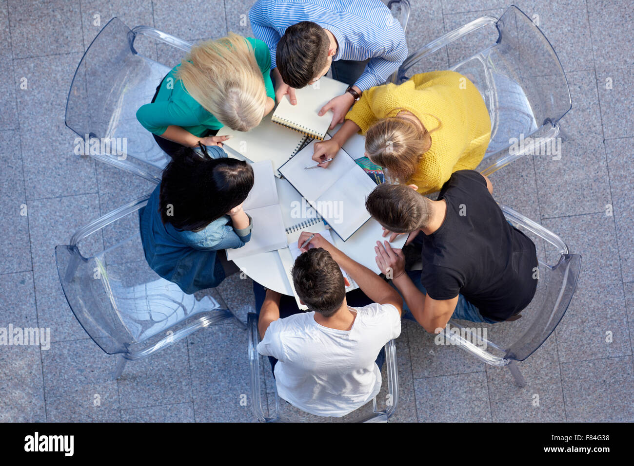 top view, group of students together at school table working homework ...