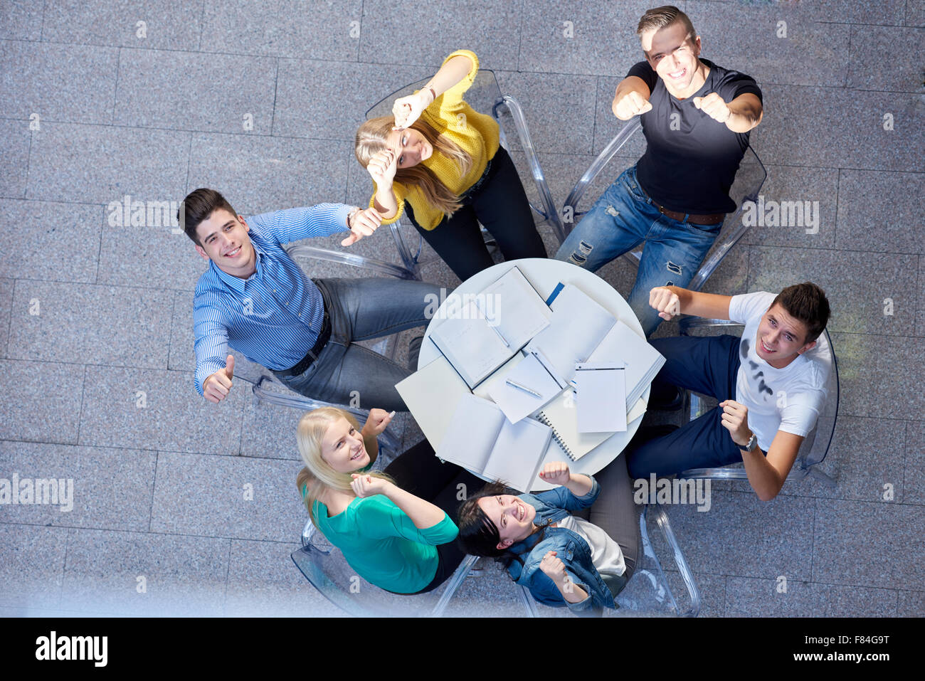 top view, group of students together at school table working homework ...