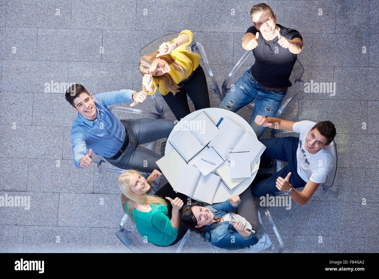 top view, group of students together at school table working homework ...
