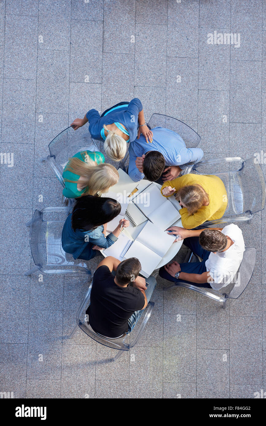 top view, group of students together at school table working homework ...