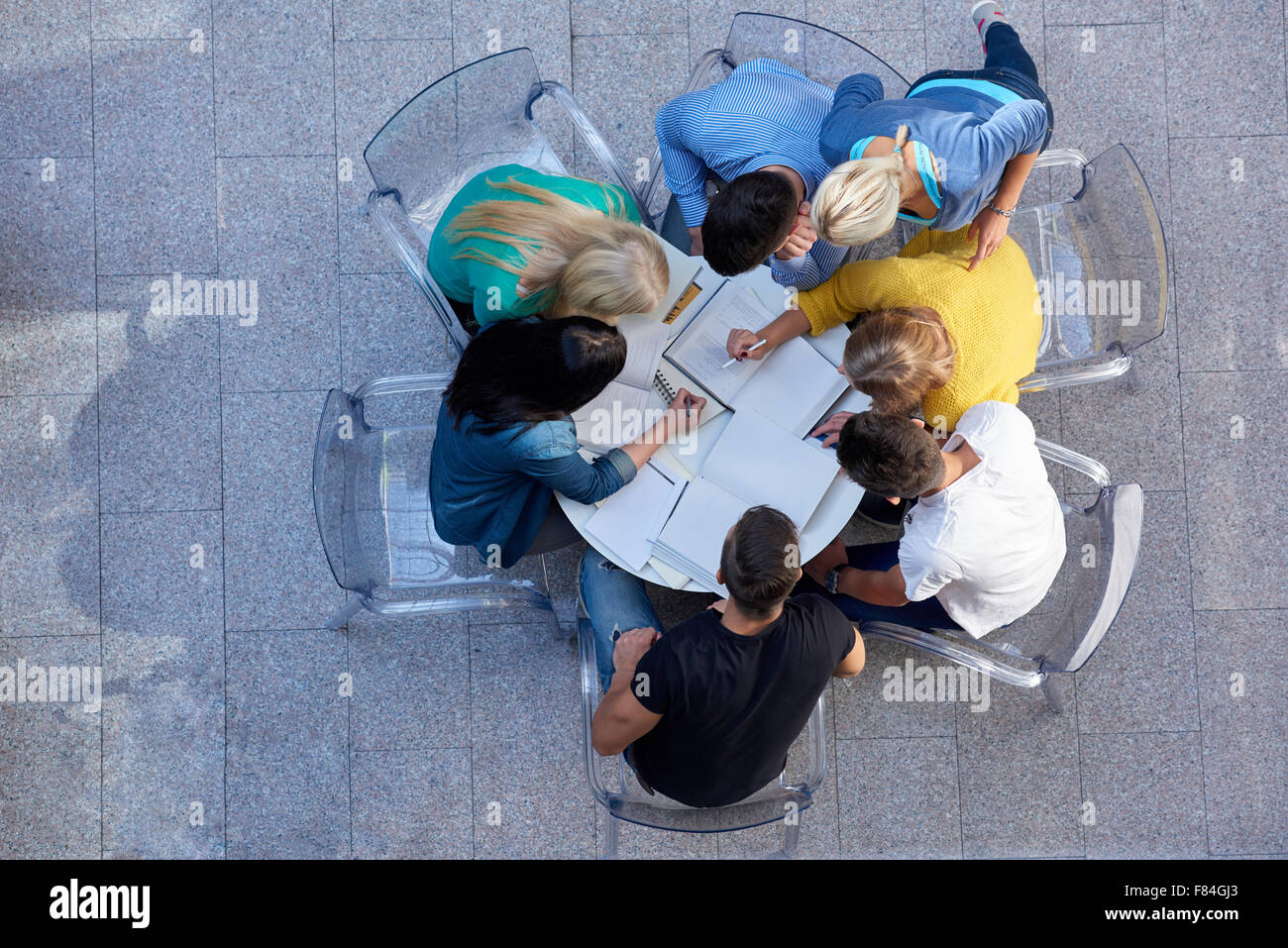 top view, group of students together at school table working homework ...