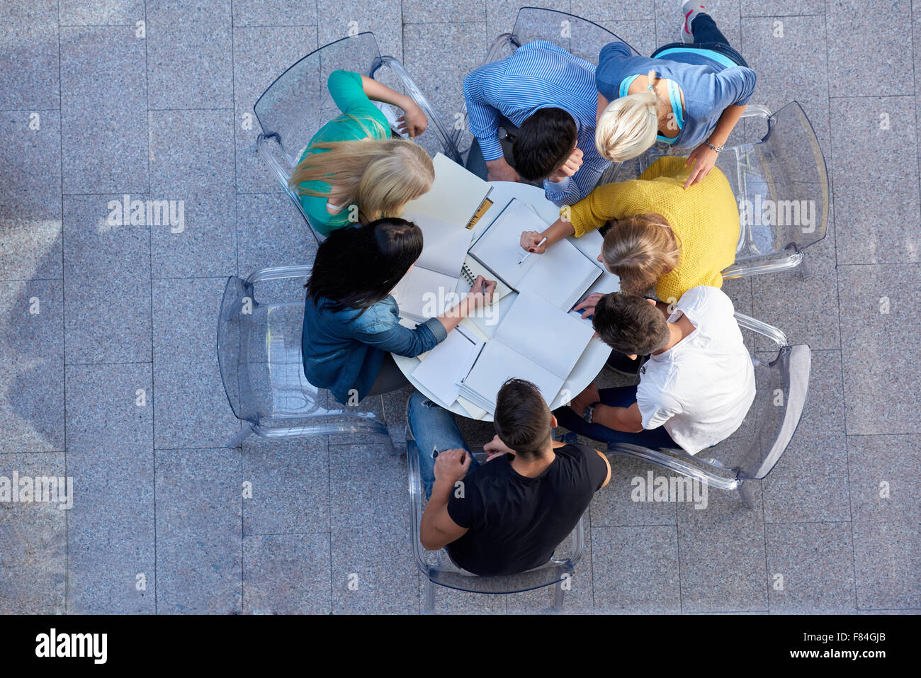 top view, group of students together at school table working homework ...