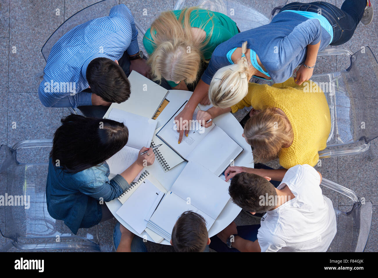 top view, group of students together at school table working homework ...