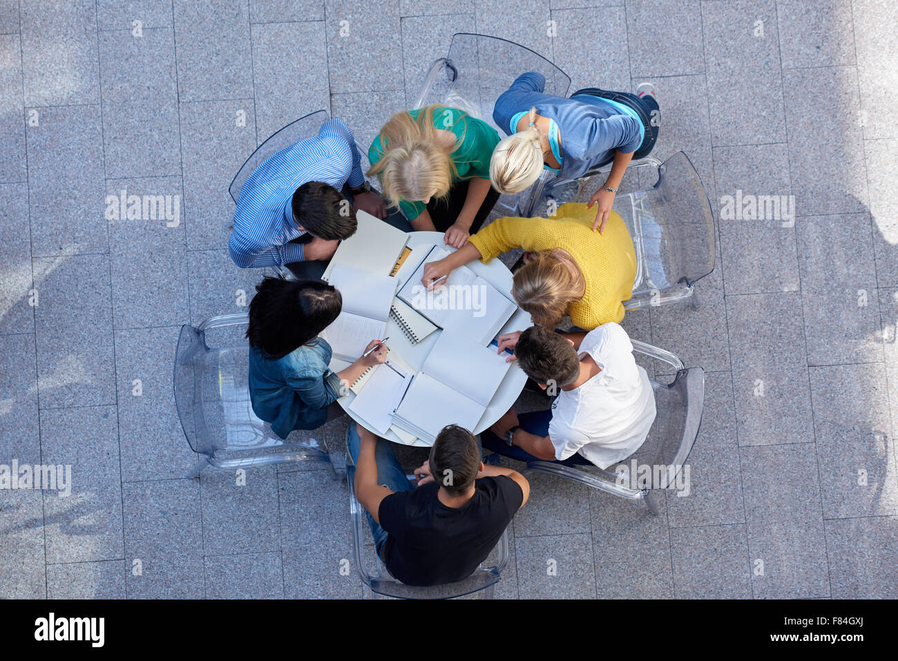 top view, group of students together at school table working homework ...