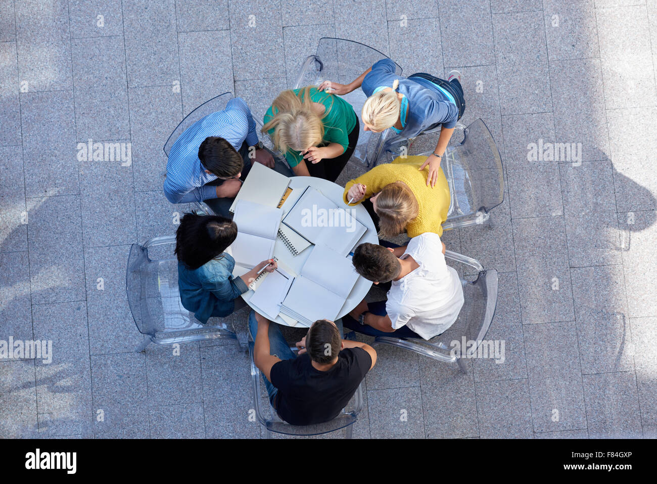 top view, group of students together at school table working homework ...