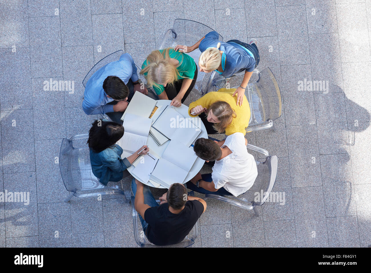 top view, group of students together at school table working homework ...