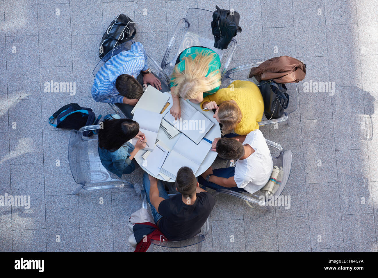 top view, group of students together at school table working homework ...