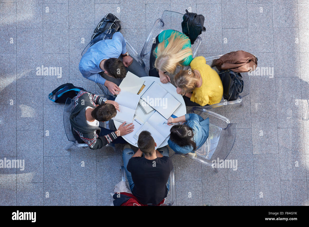 top view, group of students together at school table working homework ...