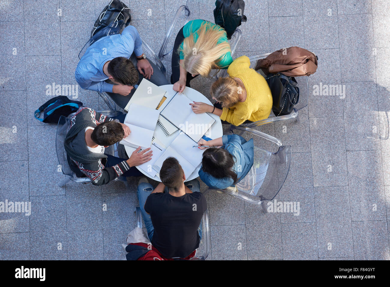 top view, group of students together at school table working homework ...