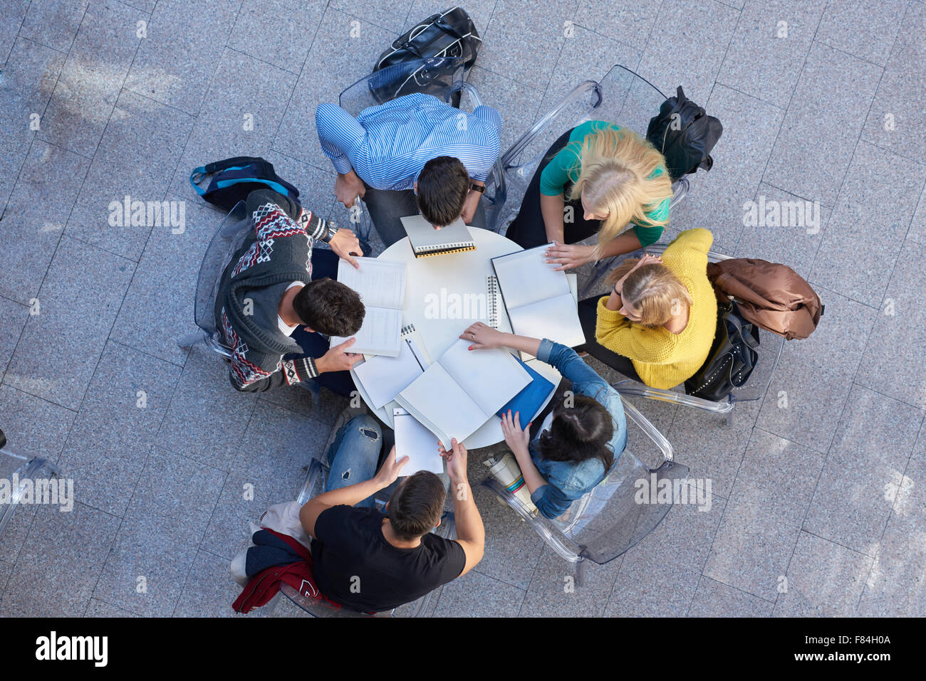 top view, group of students together at school table working homework ...