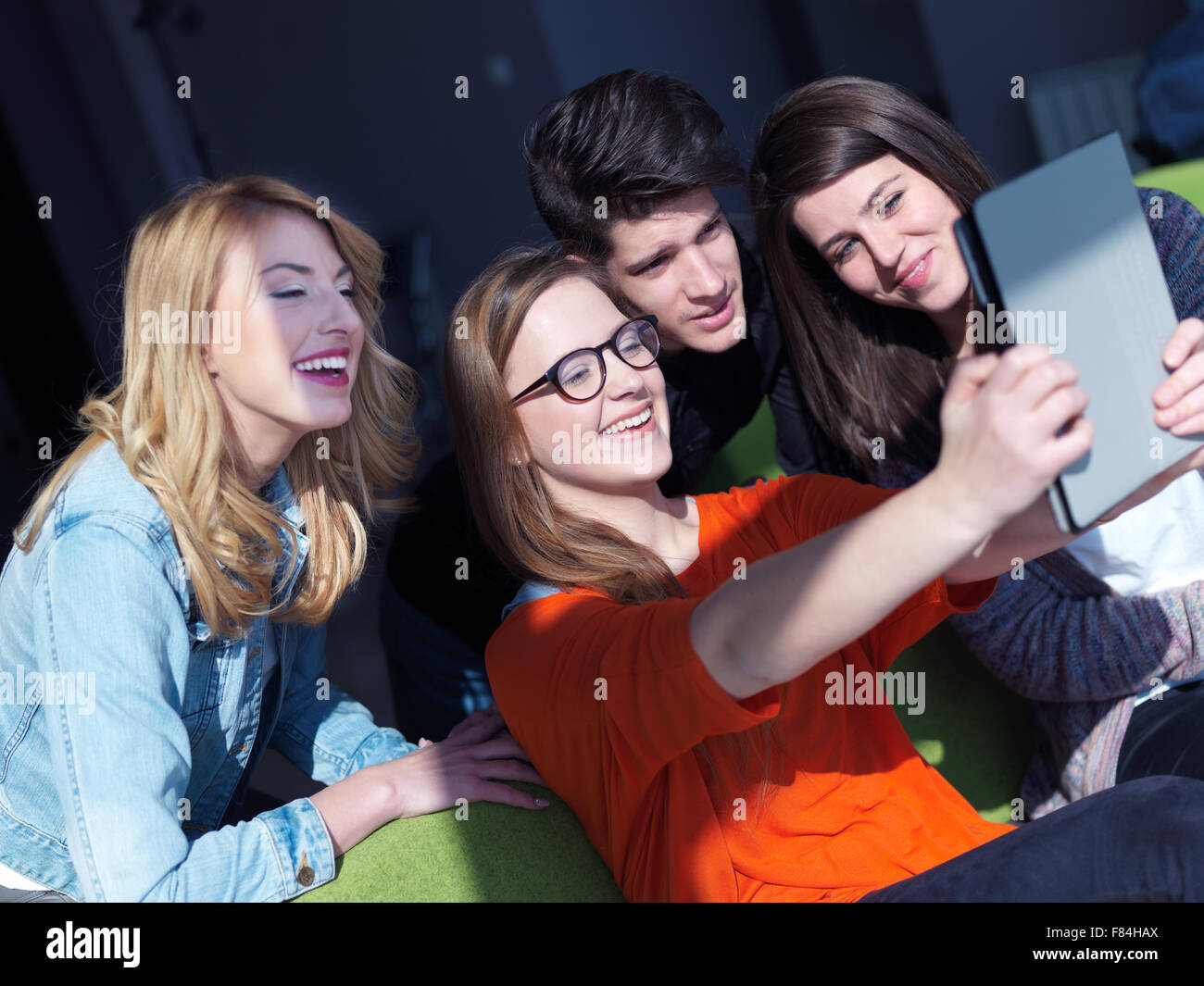 happy students group taking selfie with smartphone and tablet computer ...