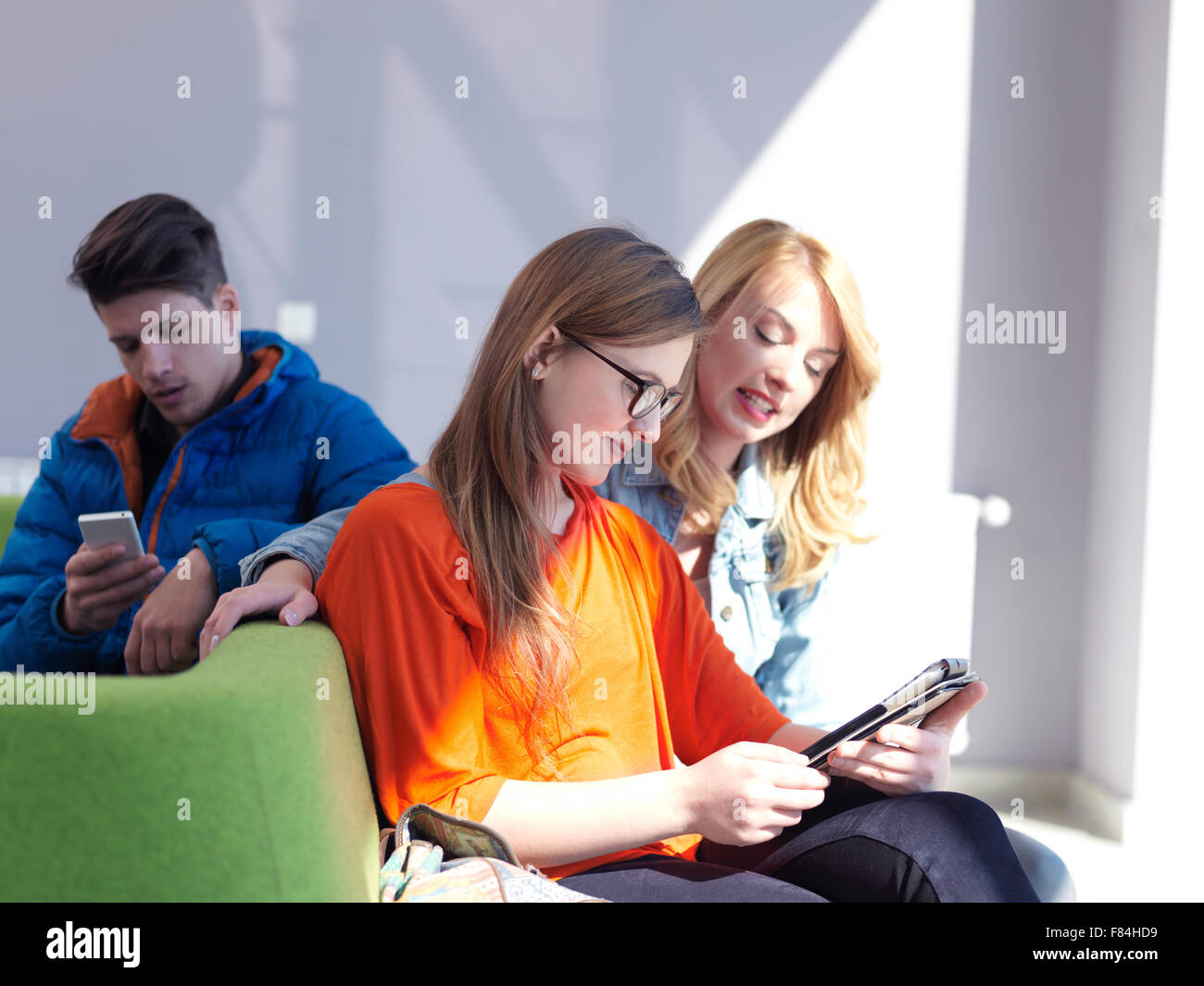 students group working on school project together on tablet computer at ...