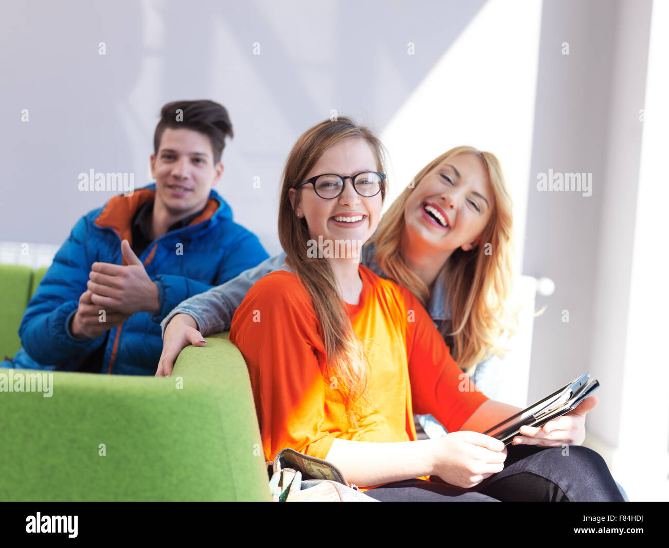 students group working on school project together on tablet computer at ...