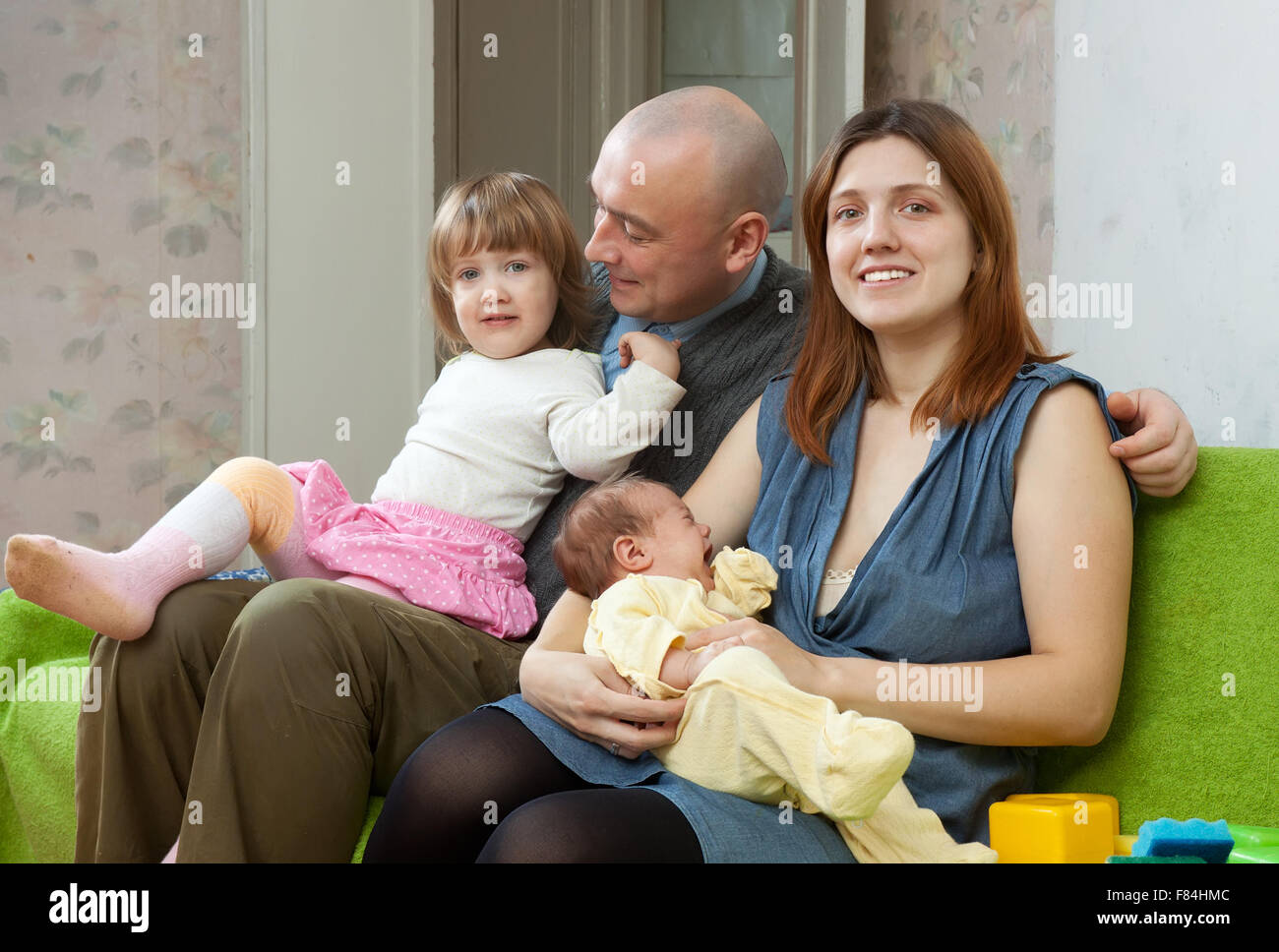 parents with their two kids at home interior Stock Photo - Alamy