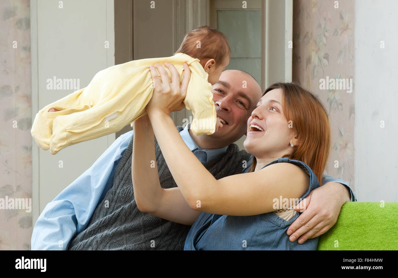 Happy parents with newborn baby in home Stock Photo - Alamy