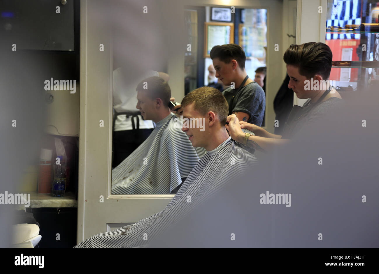 A barber working with his customer in a barber shop. Dublin, Ireland ...