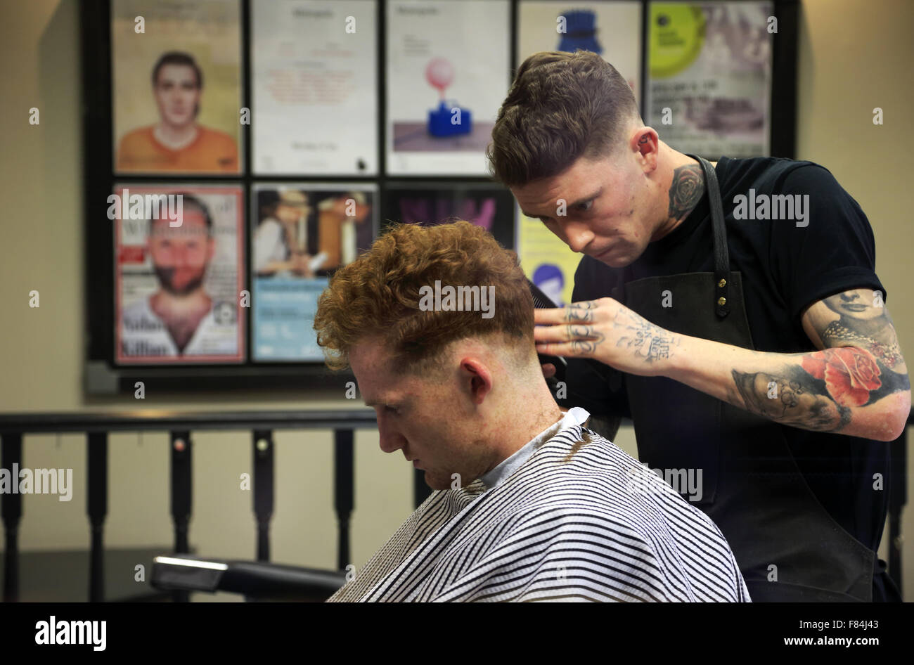 A barber working with his customer in a barber shop. Dublin, Ireland ...