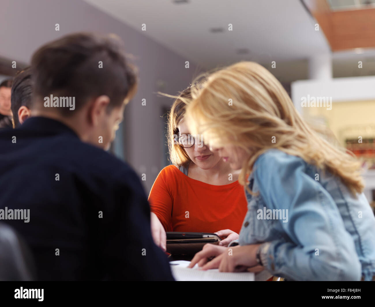 students group working on school project together on tablet computer at ...