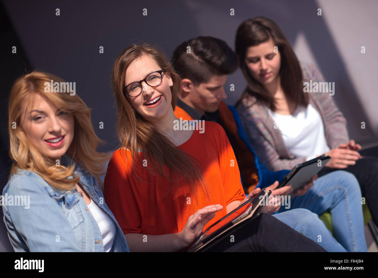 students group working on school project together on tablet computer at ...