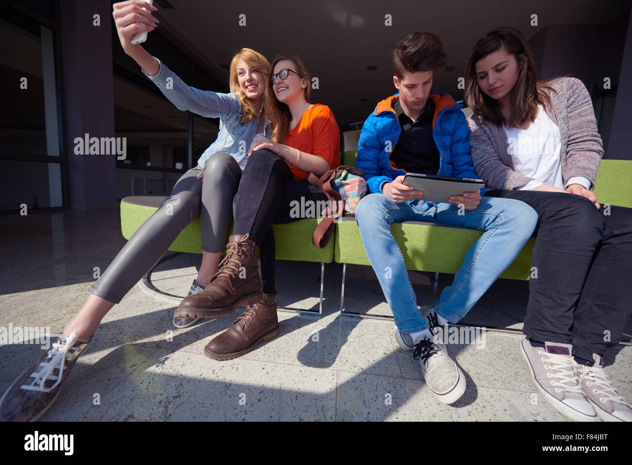 happy students group taking selfie with smartphone and tablet computer ...