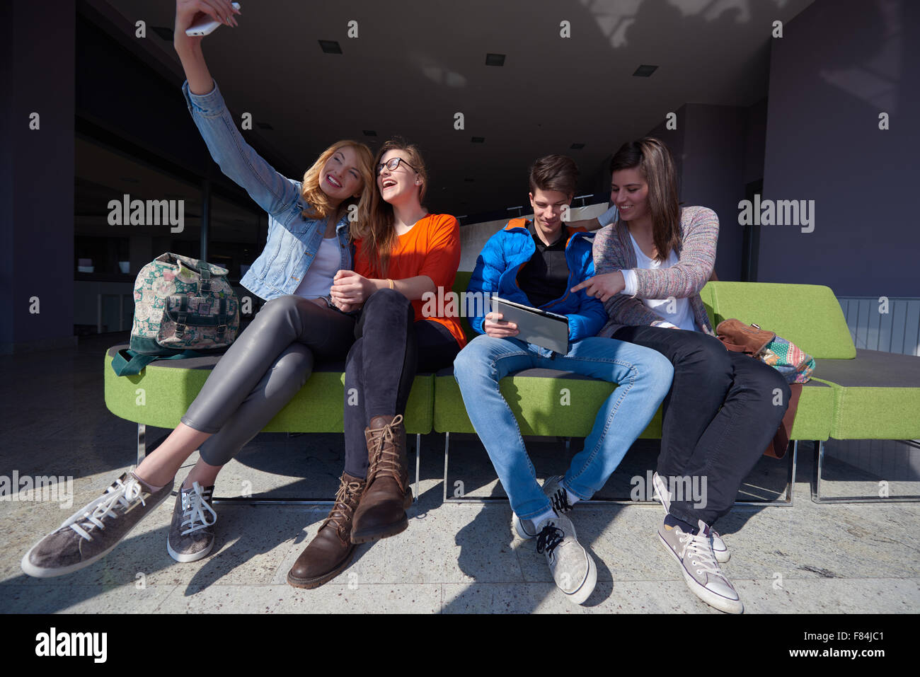 happy students group taking selfie with smartphone and tablet computer ...