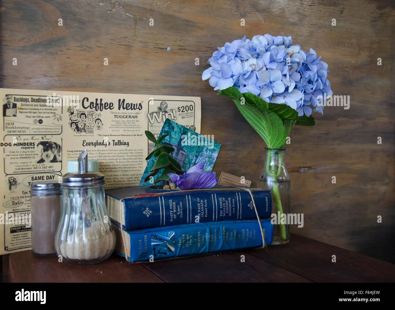 Books and flowers on a table in a coffee shop. This image includes ...