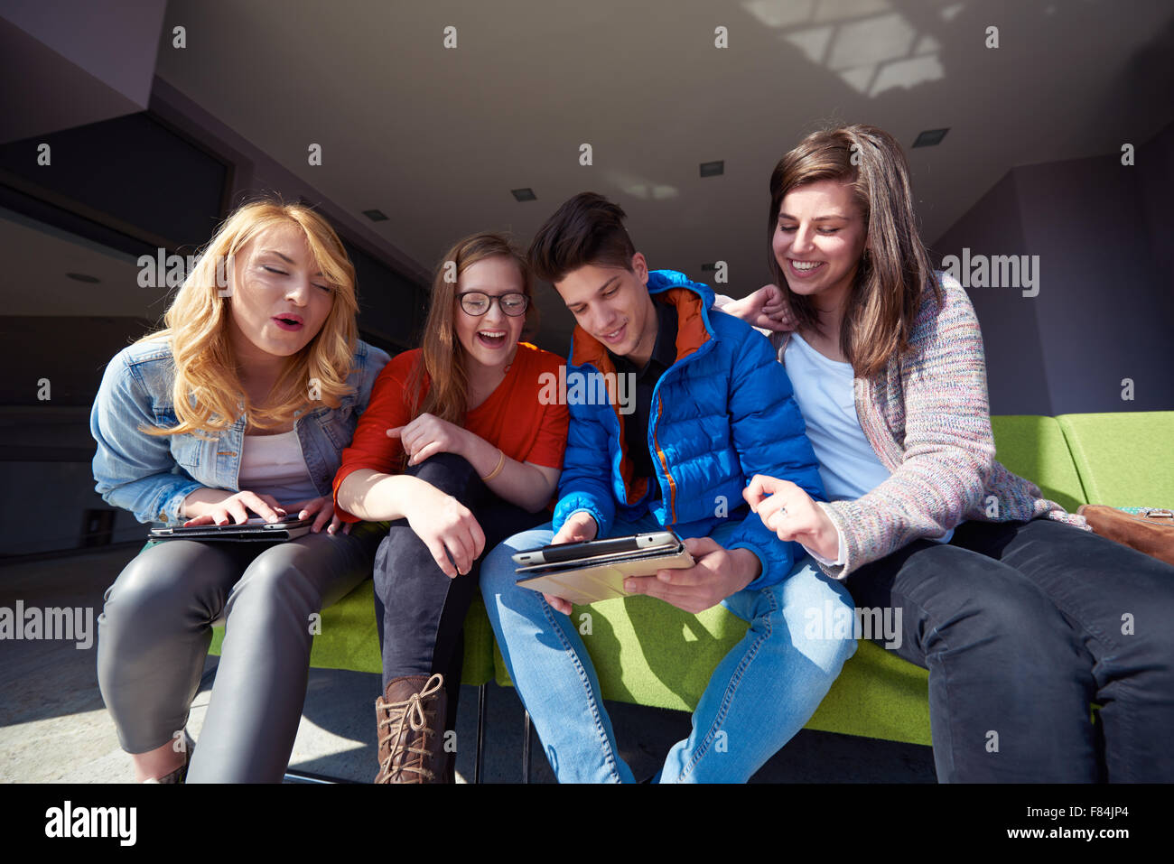 students group working on school project together on tablet computer at ...