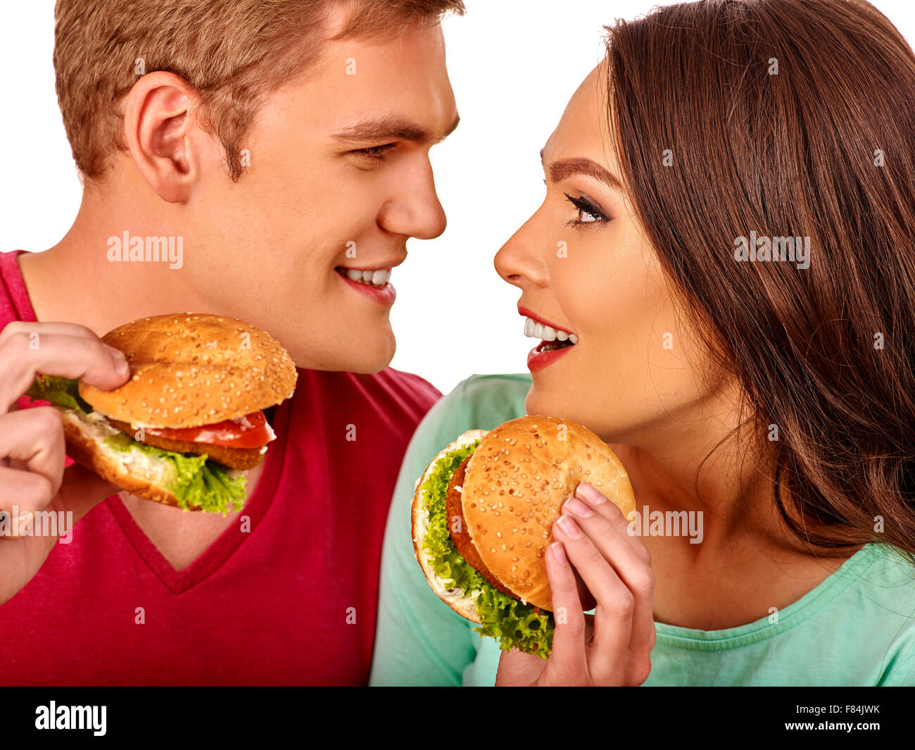 Man and woman eating big sandwich with cola. Isolated Stock Photo - Alamy