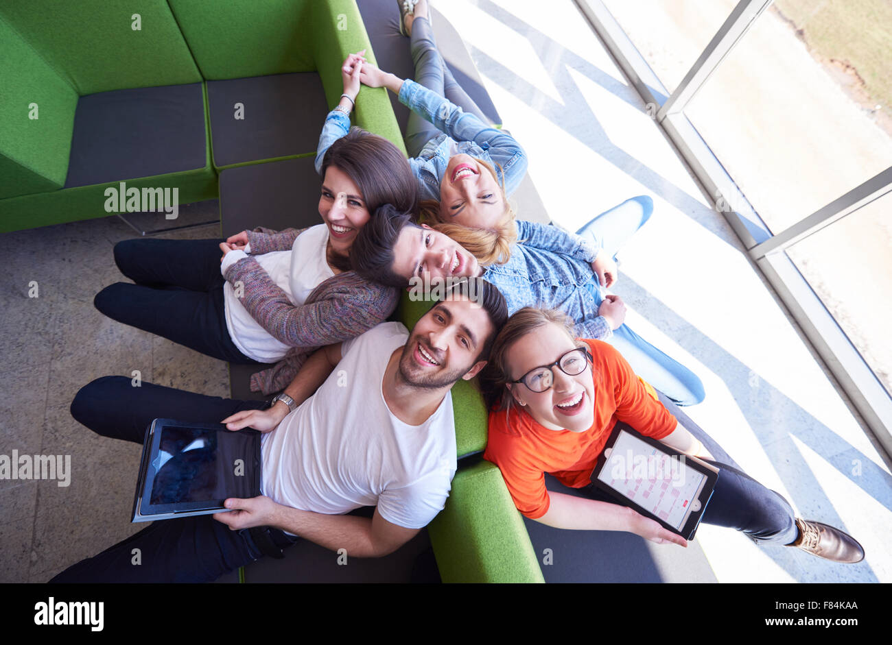 students group working on school project together on tablet computer at ...
