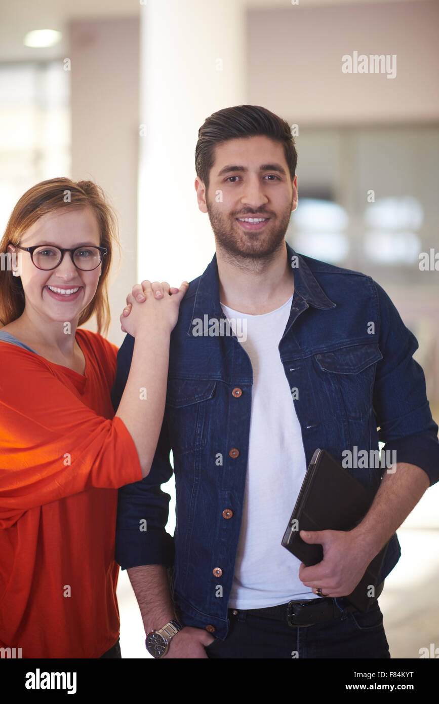 happy students couple standing together at university campus interior ...