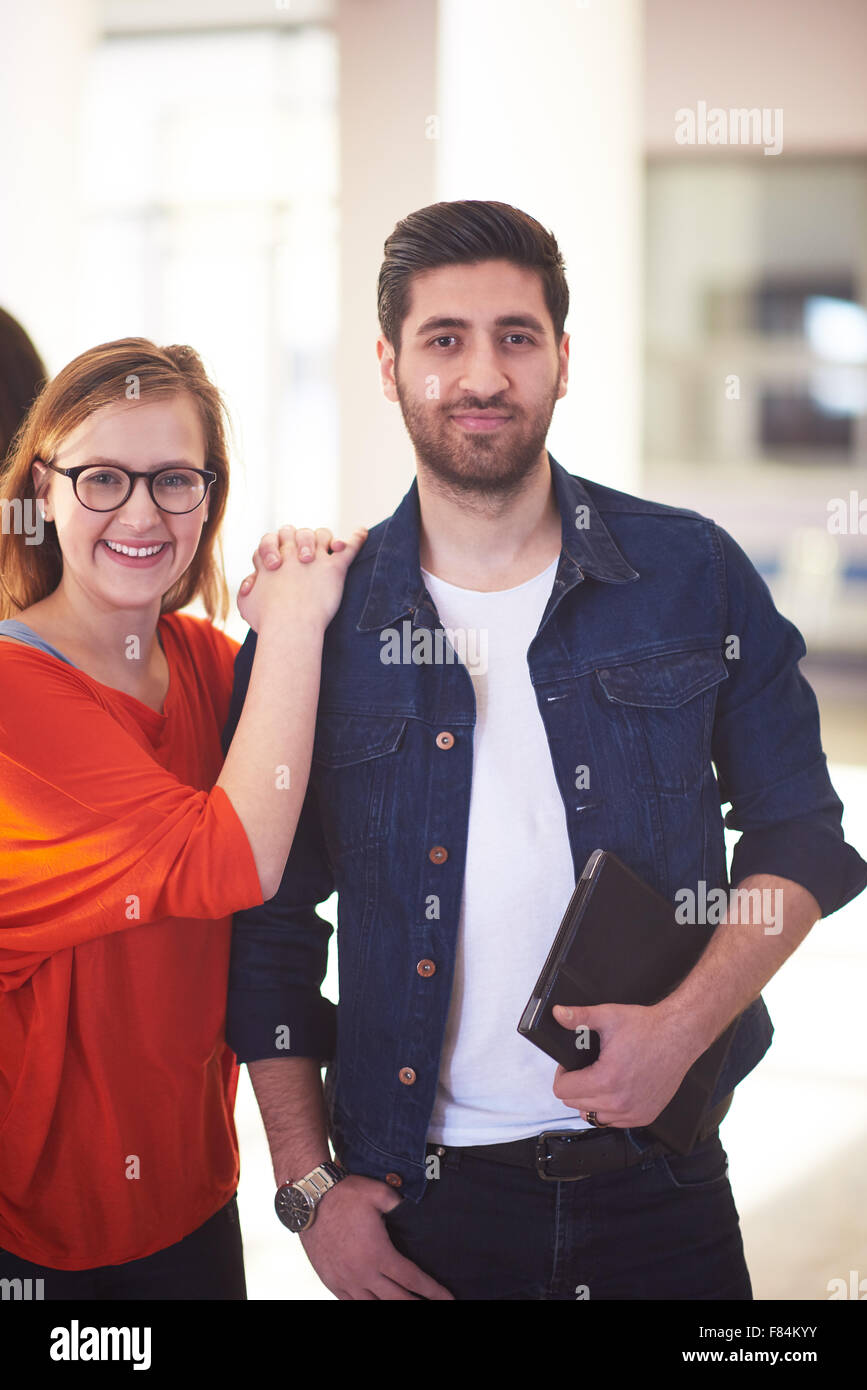 happy students couple standing together at university campus interior ...