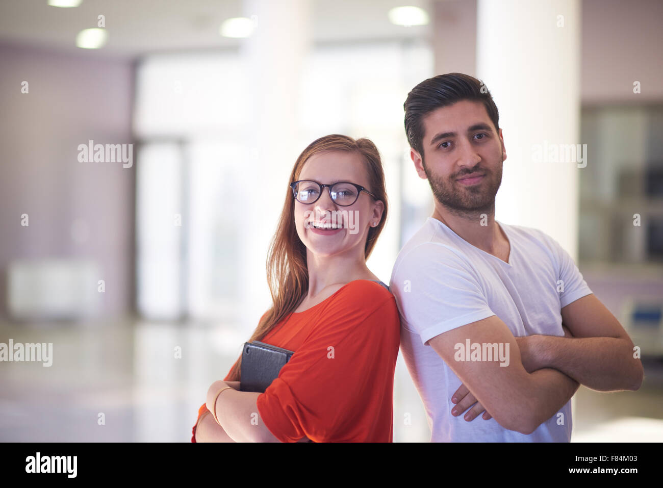 happy students couple standing together at university campus interior ...