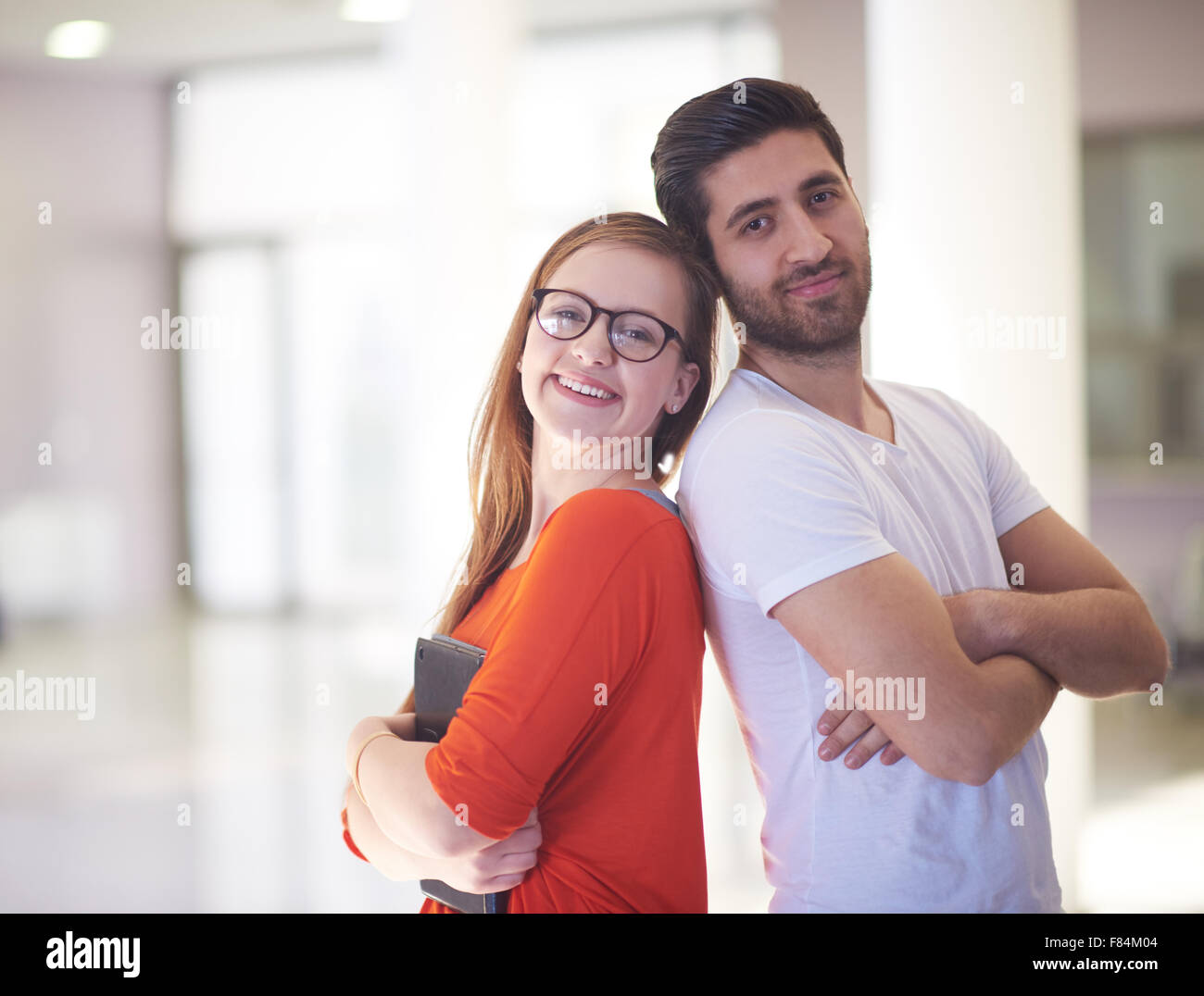 happy students couple standing together at university campus interior ...