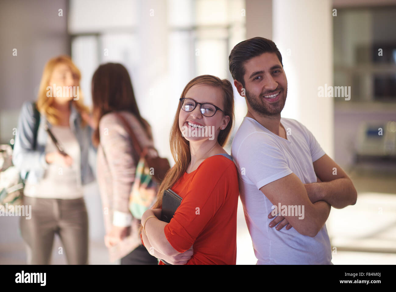 happy students couple standing together at university campus interior ...