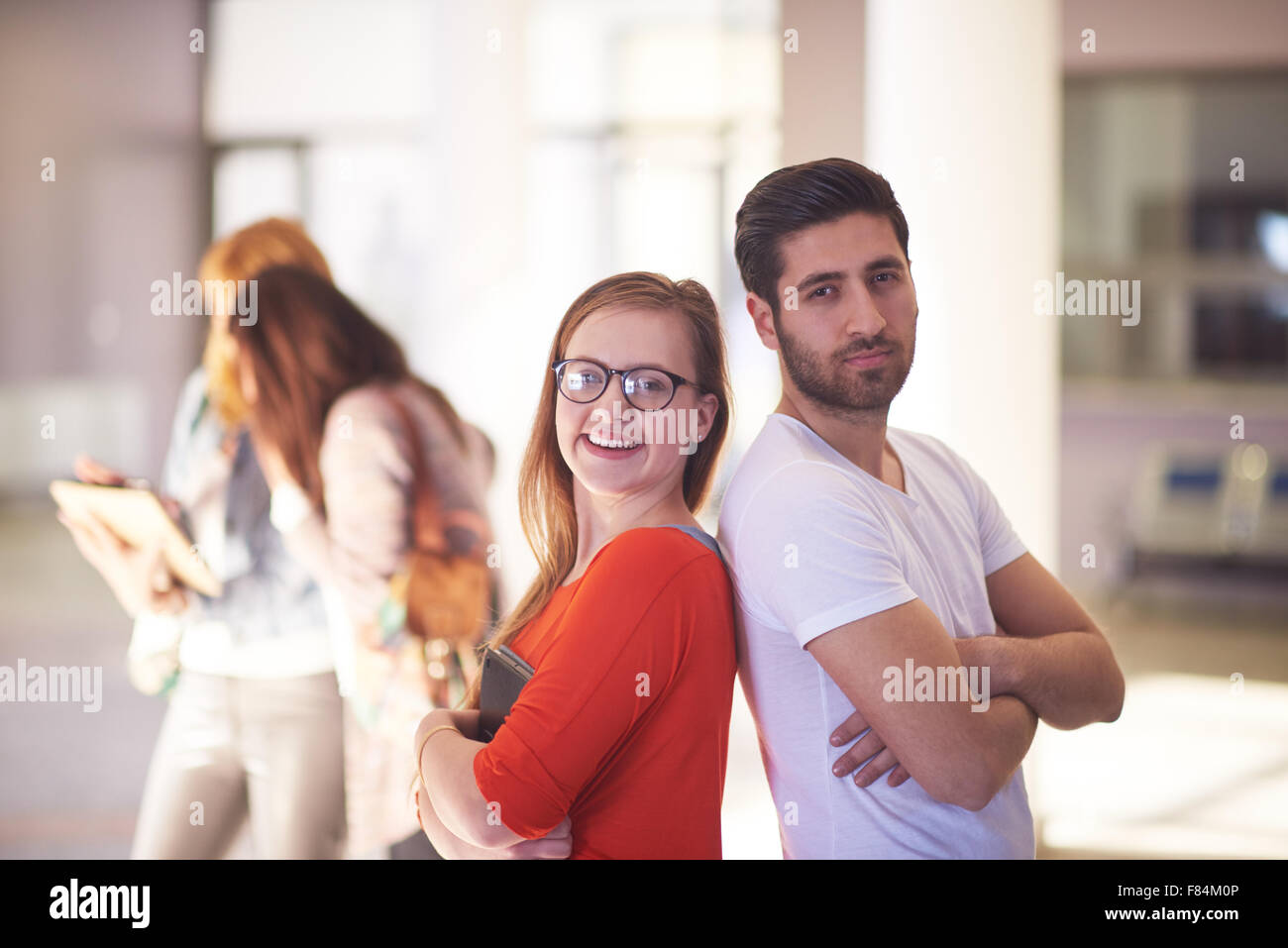 happy students couple standing together at university campus interior ...
