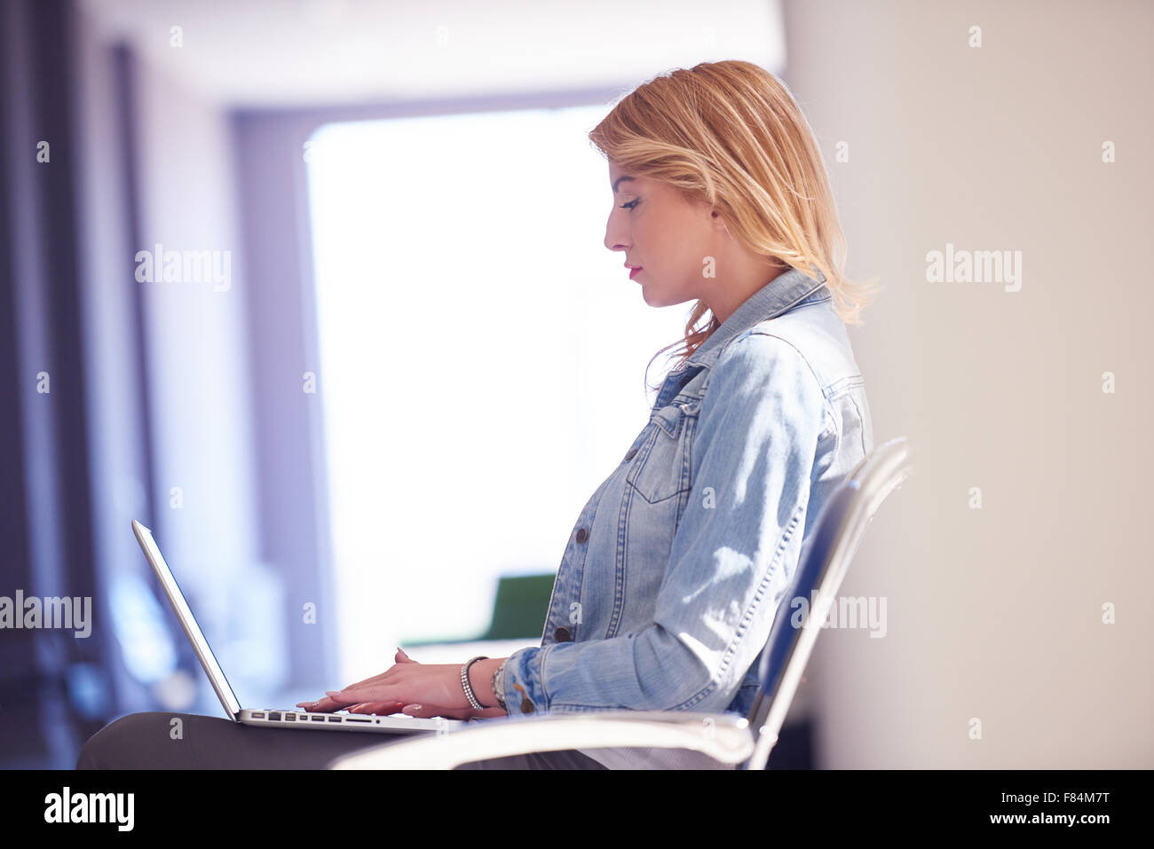 happy student girl working on laptop computer at modern school ...