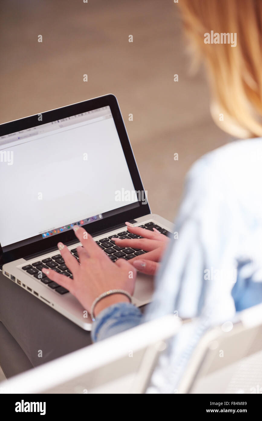 happy student girl working on laptop computer at modern school ...