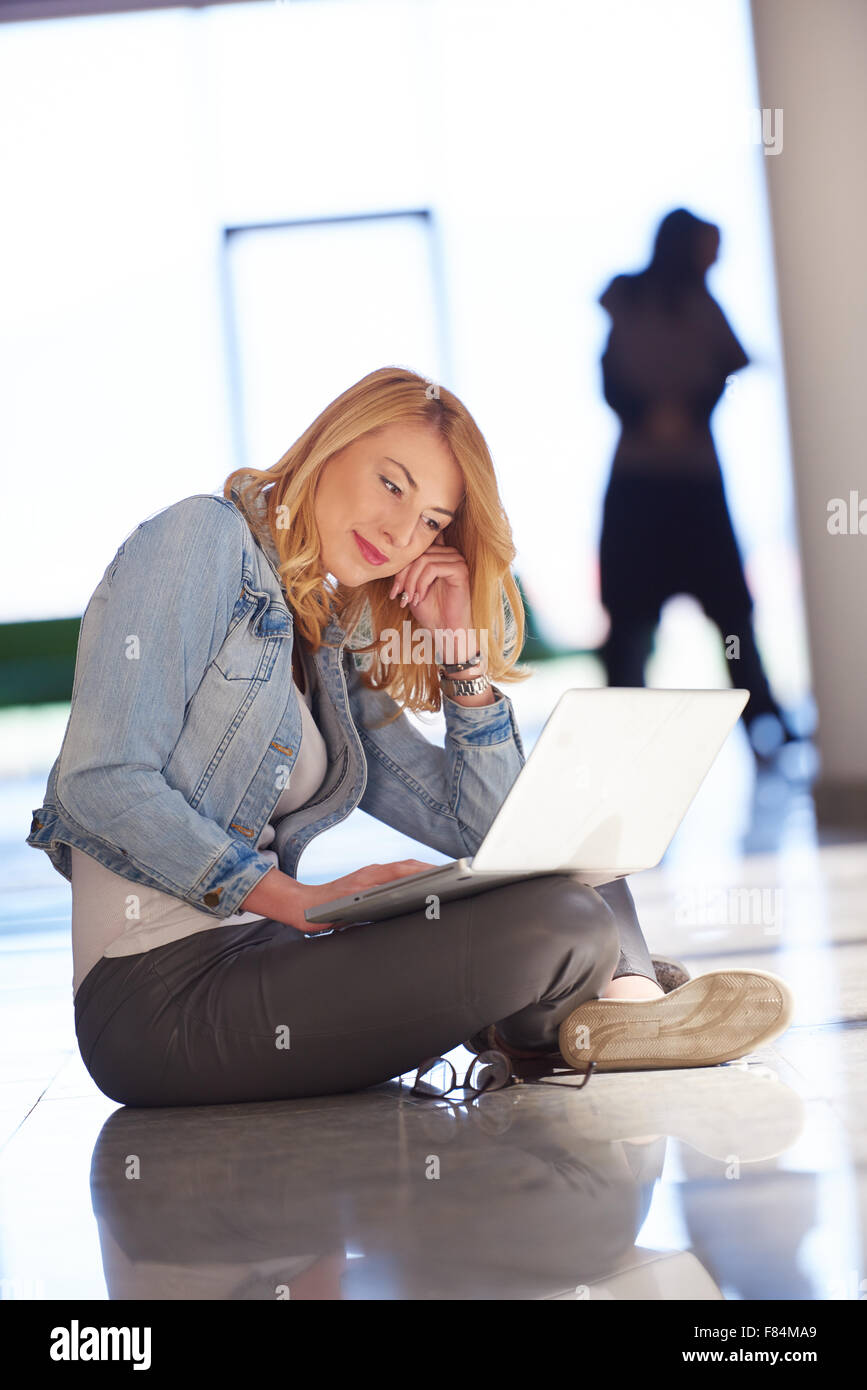 happy student girl working on laptop computer at modern school ...
