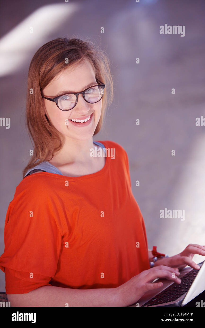 happy student girl working on laptop computer at modern school ...