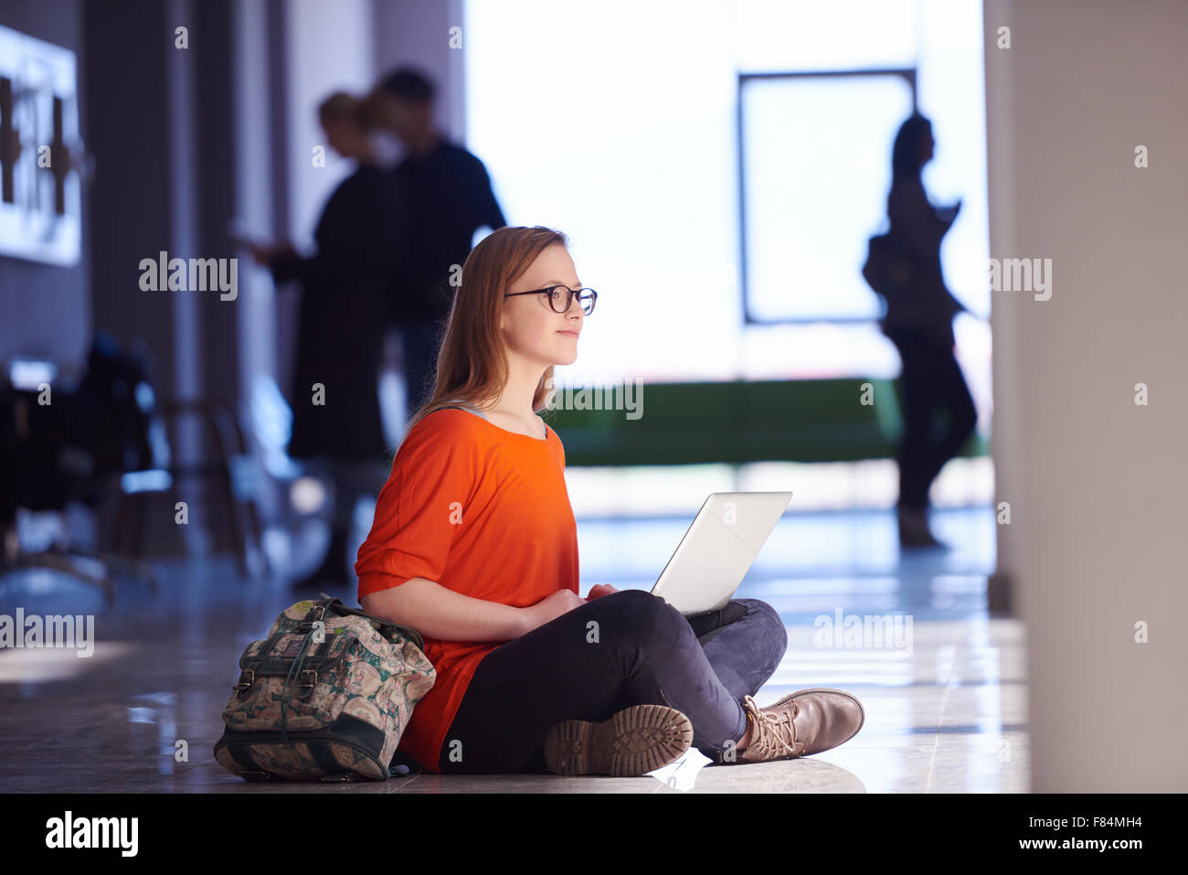 happy student girl working on laptop computer at modern school ...