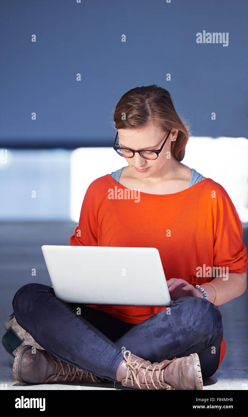 happy student girl working on laptop computer at modern school ...