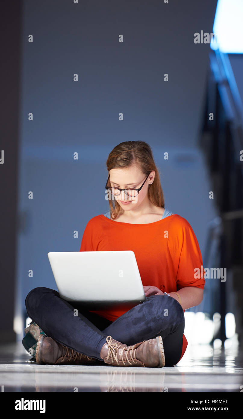 happy student girl working on laptop computer at modern school ...