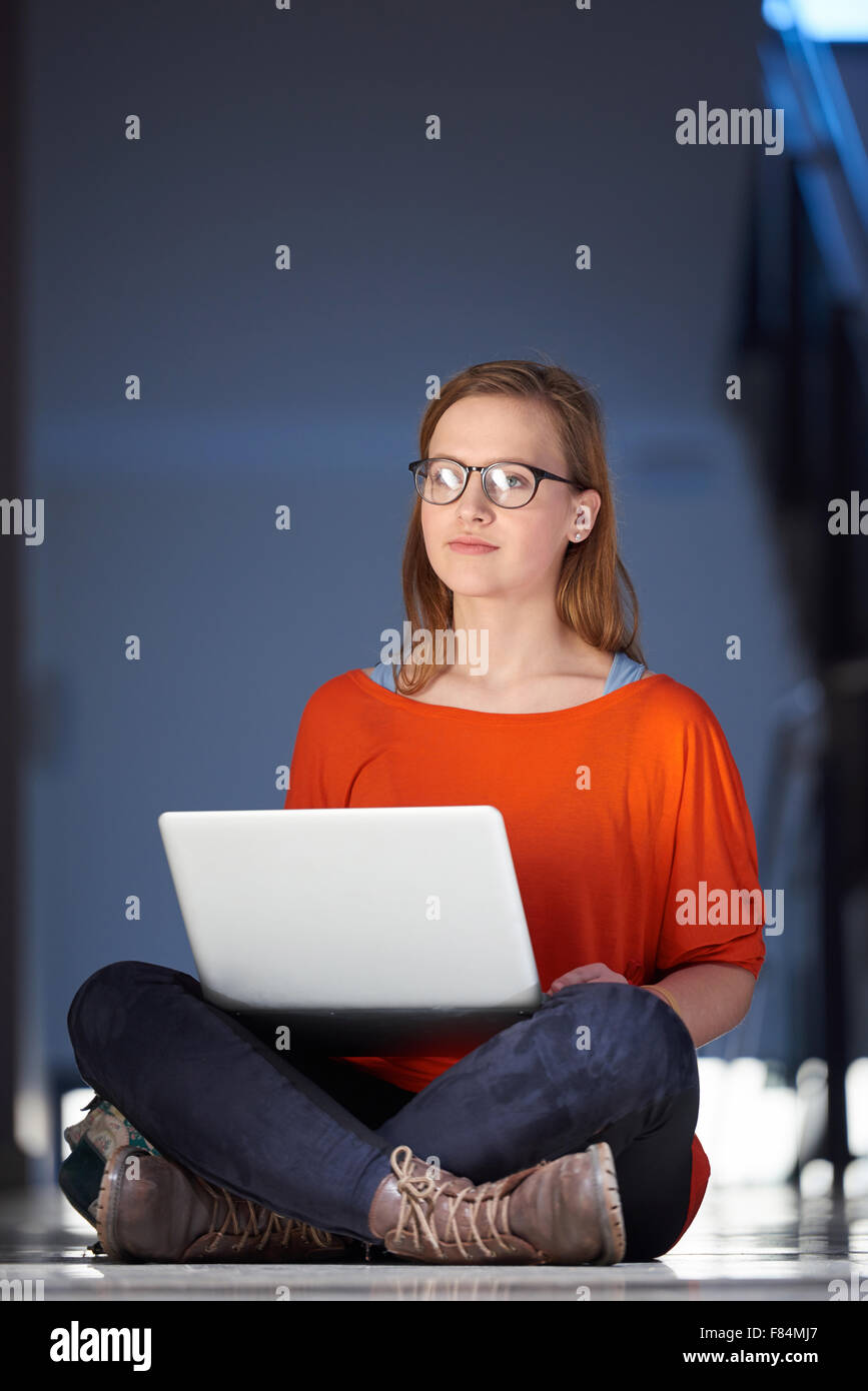 happy student girl working on laptop computer at modern school ...