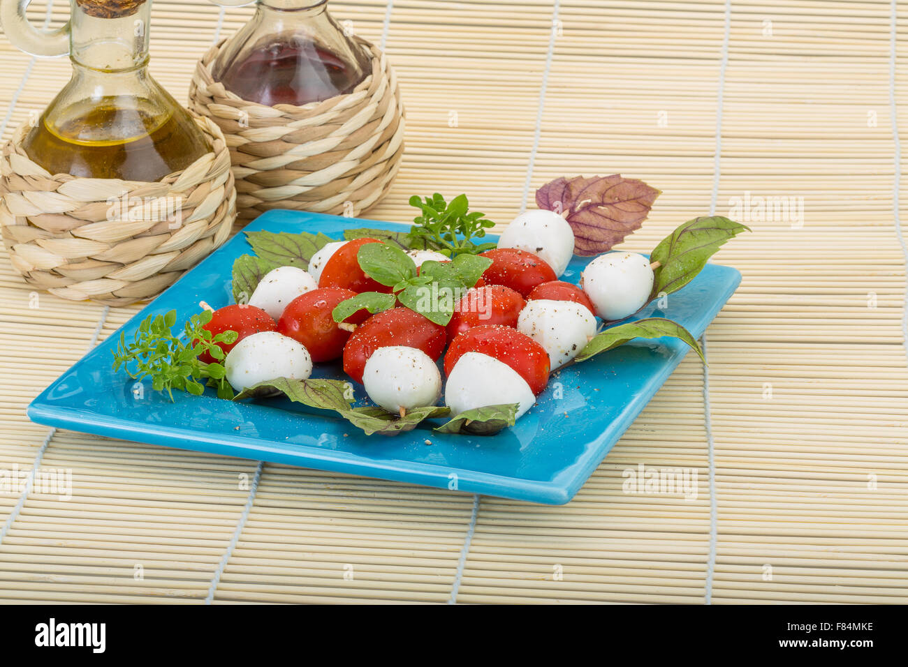 Famous italian caprese salad with fresh basil leaves Stock Photo - Alamy