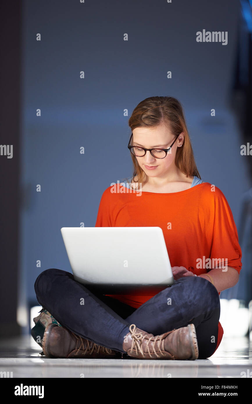 happy student girl working on laptop computer at modern school ...
