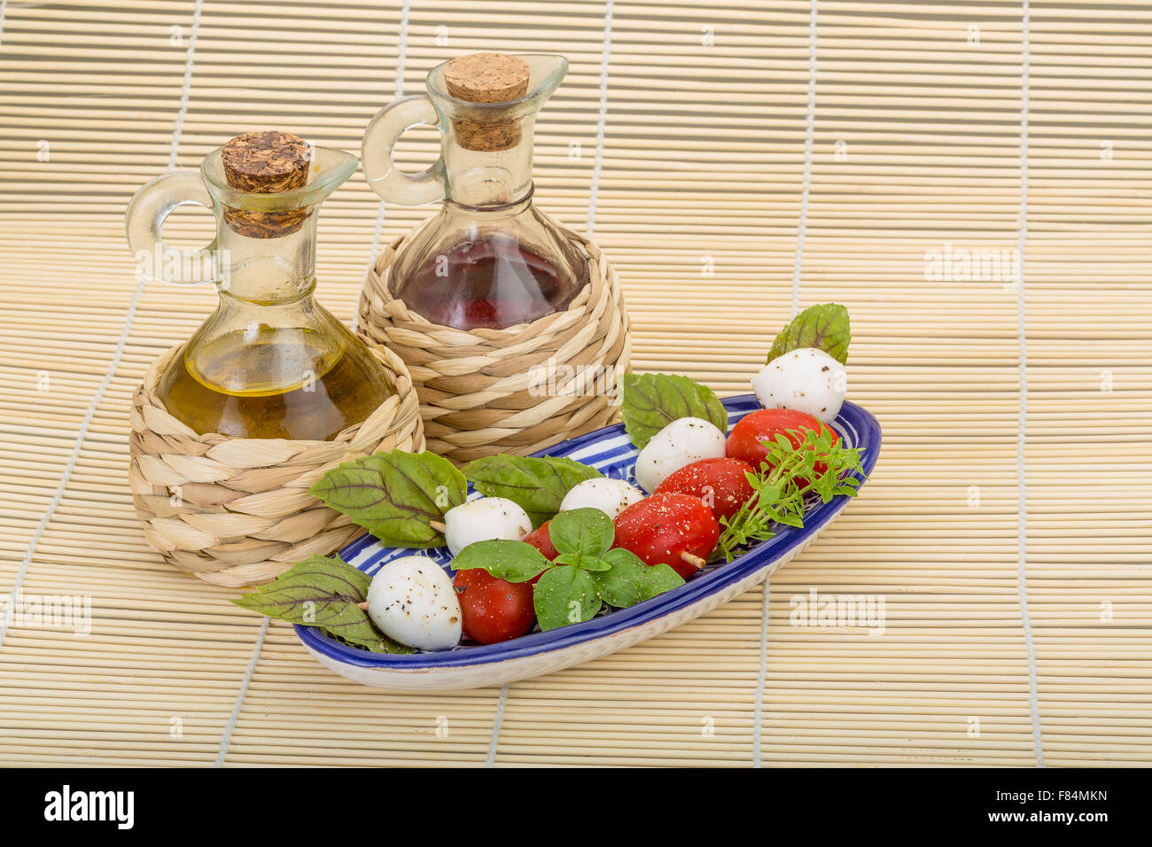 Famous italian caprese salad with fresh basil leaves Stock Photo - Alamy
