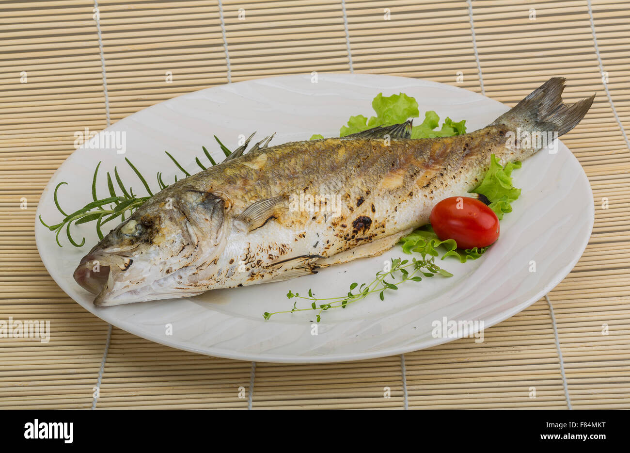 Grilled seabass fish - with rosemary and thyme Stock Photo - Alamy