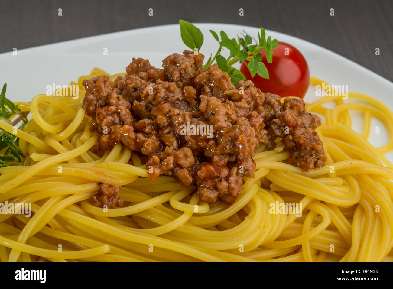 Spaghetti bolognese with rosemary and basil Stock Photo - Alamy