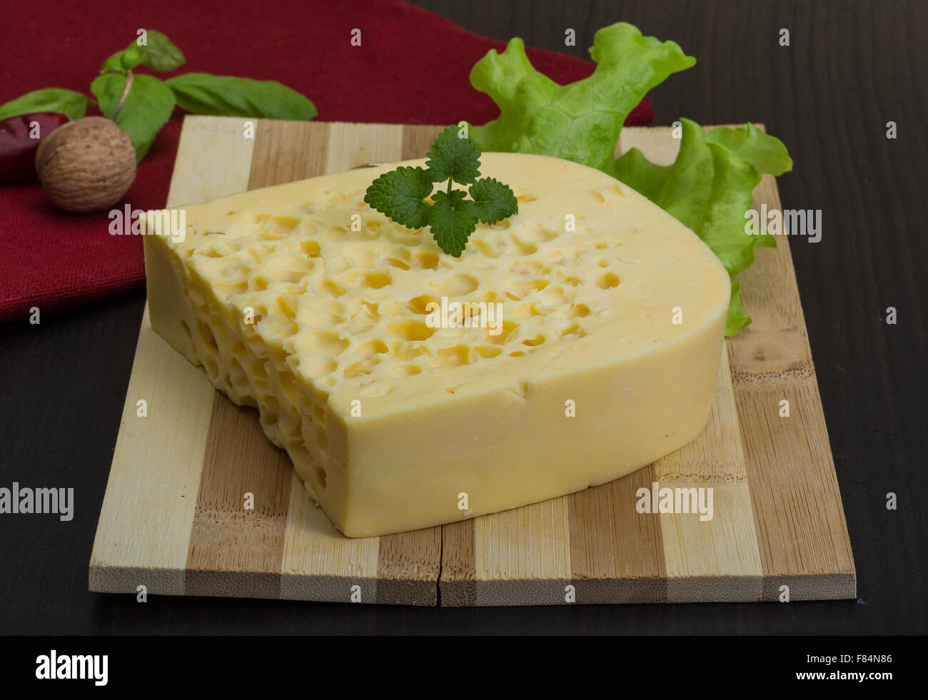 Yellow cheese - maasdam with salad leaves Stock Photo - Alamy