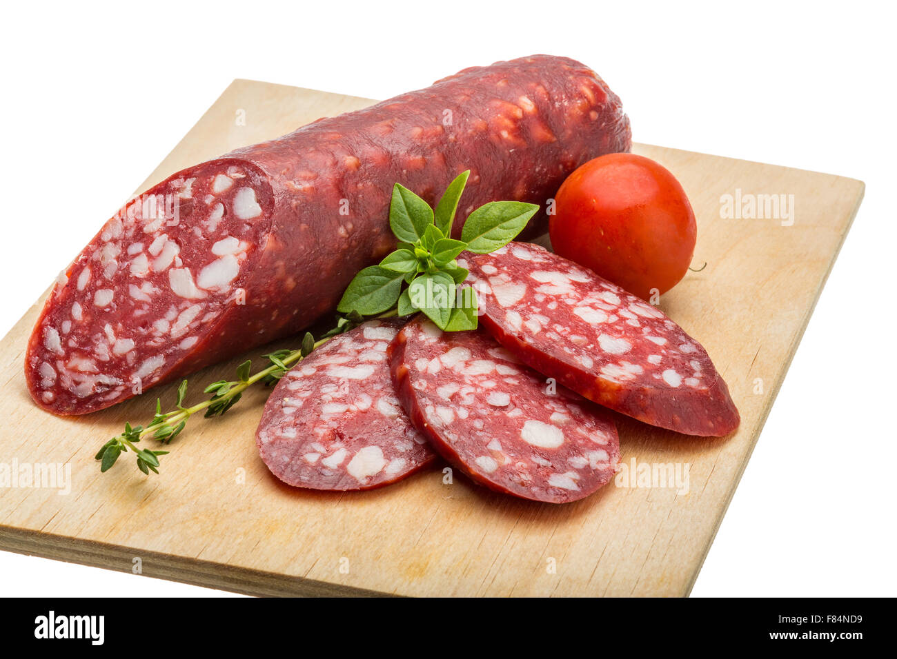 Salami sausages sliced with basil and tomato Stock Photo - Alamy